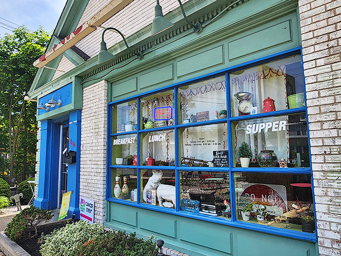 The mint-green exterior of Shut Up and Eat beckons hungry travelers with colorful outdoor seating and a sign that gets straight to the point.