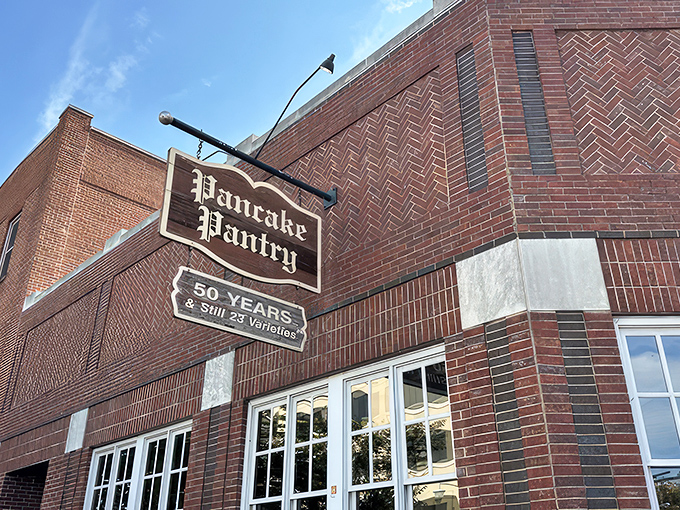 The iconic brick exterior of Pancake Pantry proudly displays its "50 Years & Still 23 Varieties" sign, a testament to perfecting rather than changing a good thing.