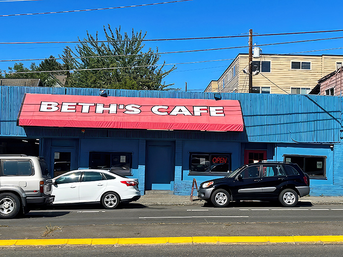 The iconic blue exterior with its bright red awning has been beckoning hungry Seattleites for generations, like a breakfast lighthouse in a sea of ordinary restaurants.