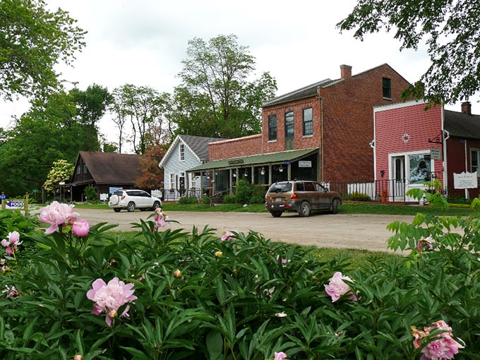 Historic storefronts framed by blooming peonies &ndash; Bentonsport's main street looks like a film set where modern life agreed to take a breather.