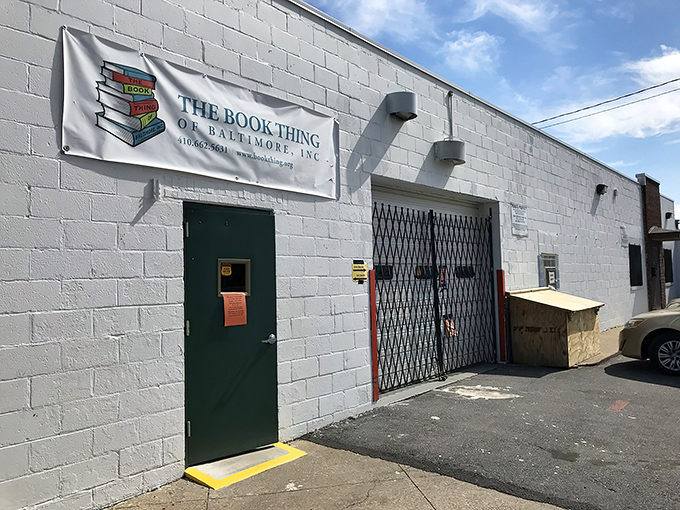 The unassuming exterior of literary heaven &ndash; a white cinder block building with a simple banner that promises bookish treasures beyond the green door.