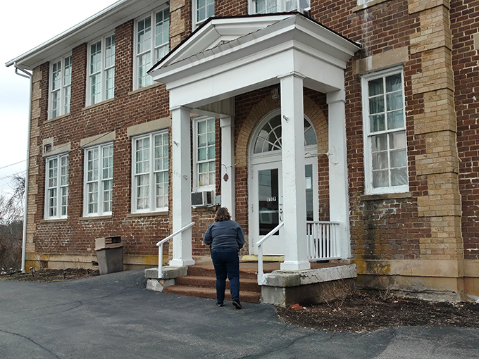 The stately brick exterior of Schoolhouse Fabrics stands as a testament to its educational past, now housing three floors of textile treasures.