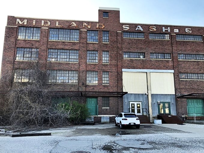 The imposing brick exterior of Midland Arts & Antiques Market still proudly displays its "SASH & DOOR" industrial heritage, promising treasures within those weathered walls.