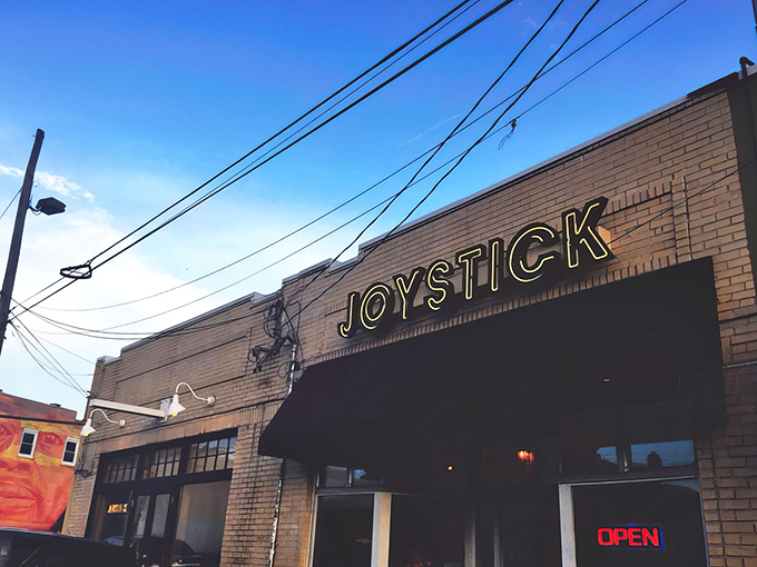 The unassuming brick exterior of Joystick Gamebar beckons with retro neon promise – like finding a secret level in your favorite childhood game.