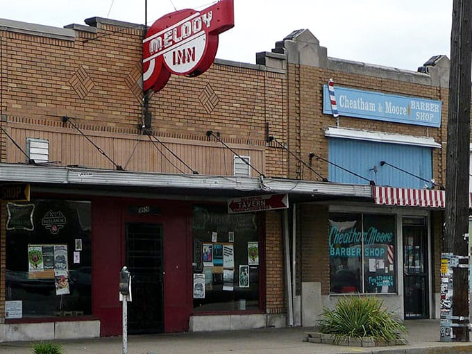 The neon glow of Melody Inn beckons like a lighthouse for music lovers, with its unassuming exterior hiding decades of Indianapolis rock history.