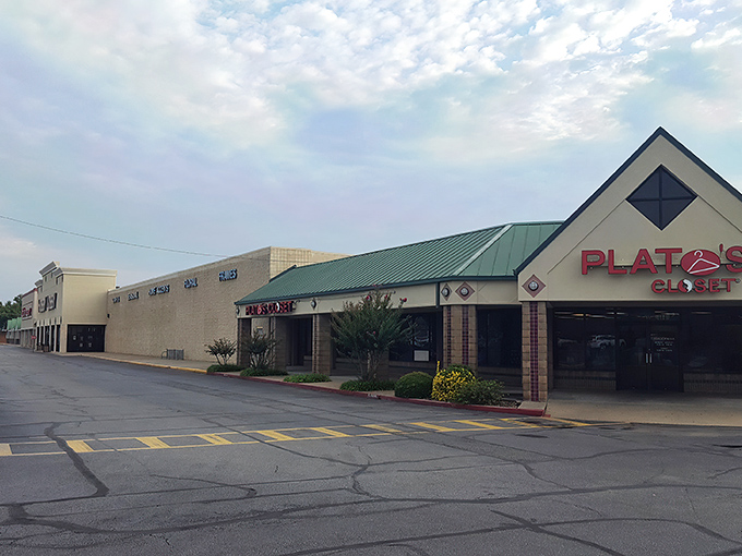 The distinctive green-roofed exterior of Plato's Closet in Fayetteville welcomes fashion hunters with the promise of treasures within.