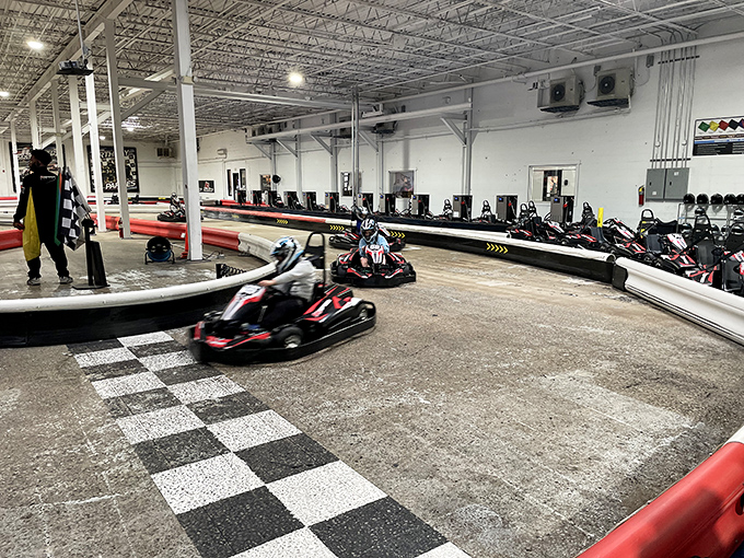 The checkered flag awaits as electric karts zoom around K1 Speed's professionally designed indoor track. Racing dreams come true regardless of weather outside.