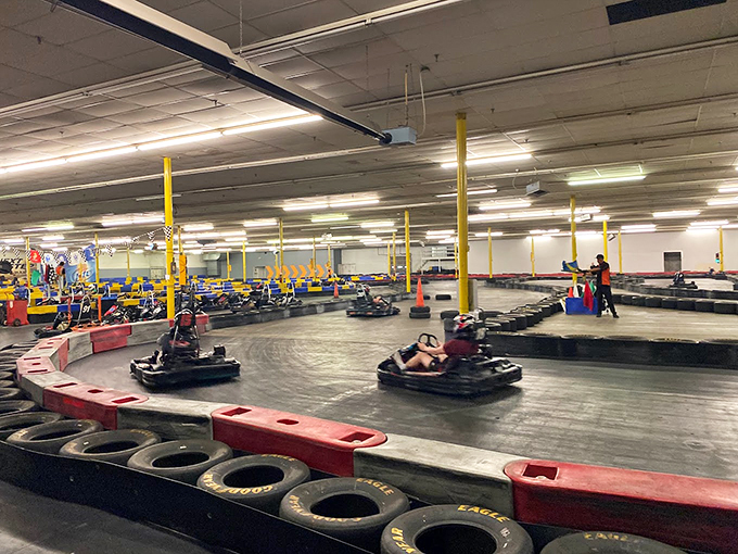 The sprawling indoor track beckons speed enthusiasts with its winding course and colorful barriers. Racing nirvana awaits under these fluorescent lights.