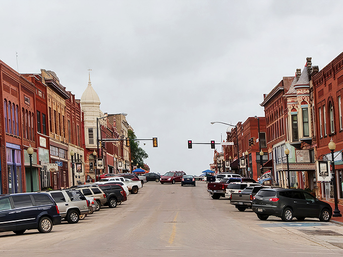 Guthrie's Victorian storefronts stand proudly like architectural time travelers. That mint-green Daylight Donuts sign promises sweet rewards for early risers. 
