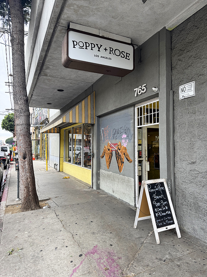 The sunshine-yellow exterior of Poppy + Rose beckons like a culinary lighthouse amid downtown LA's Flower District, promising comfort food worth the journey.