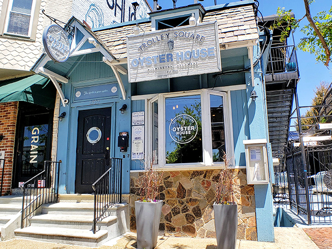 The blue fa&ccedil;ade of Trolley Square Oyster House stands like a maritime beacon in Wilmington, promising seafood treasures within those weathered wooden signs.