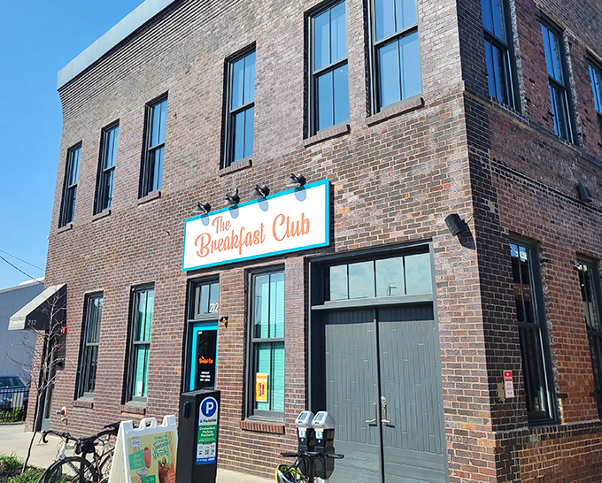 The turquoise-framed sign against rustic brick promises a breakfast revolution hiding behind that unassuming door at 212 East 3rd Street.