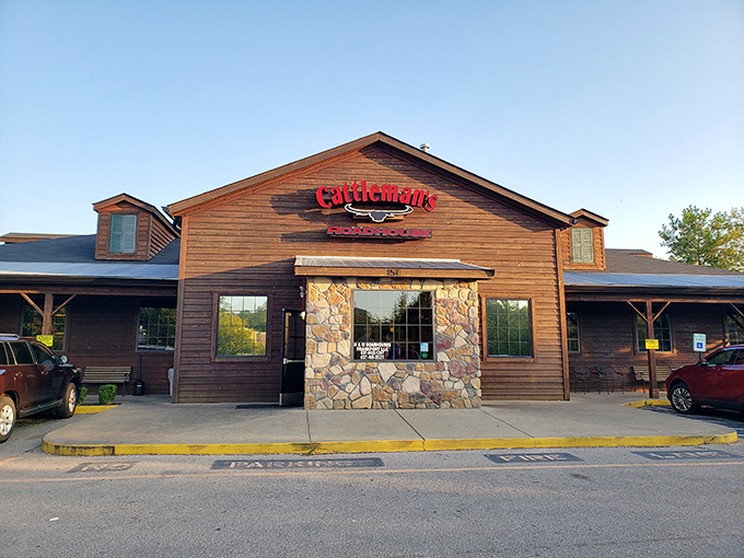 The rustic wooden exterior of Cattleman's Roadhouse beckons like an old friend, promising comfort and satisfaction within those stone-accented walls.
