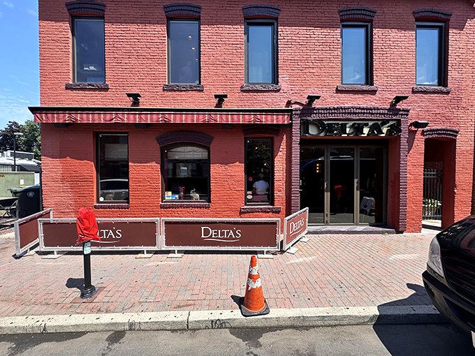 Delta's distinctive brick facade glows with promise at dusk, like a Southern lighthouse beckoning hungry travelers to safe harbor.