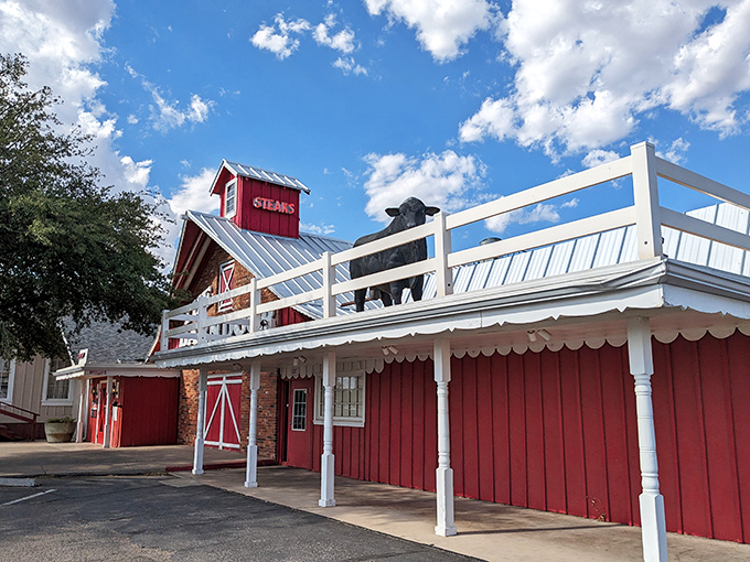 The iconic red barn facade beckons hungry travelers like a carnivorous lighthouse guiding you to beef paradise.