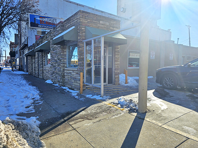 The stone facade and iconic blue sign of The Beacon stand as a culinary lighthouse on Douglas Avenue, guiding hungry Wichitans home since decades past.