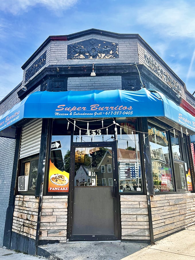 The iconic Super Burrito's sign glows like a beacon of hope for hungry travelers. That cartoon chef knows what you're craving before you do.