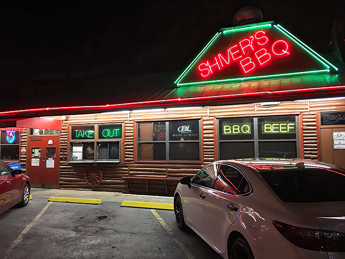 The iconic red roof of Shiver's BBQ stands like a barbecue beacon in Homestead, promising smoky delights under Florida's endless blue sky.