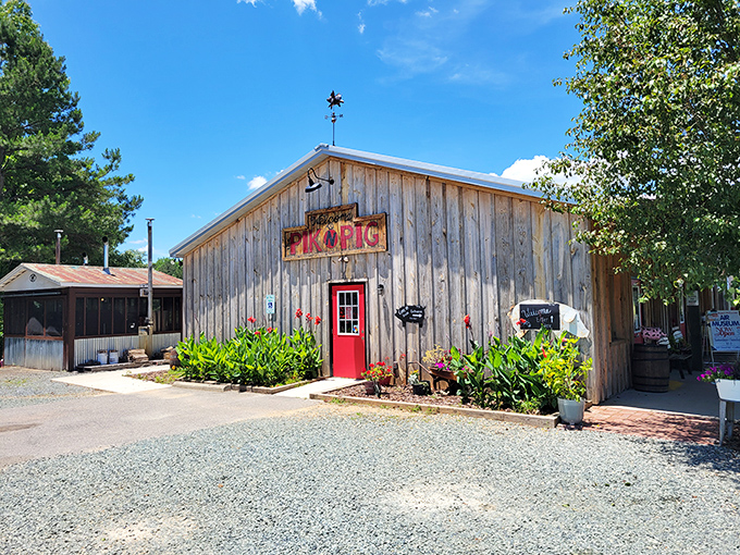 The weathered wooden exterior with that bold red door isn't trying to impress anyone&mdash;and that's precisely why it does. Southern barbecue authenticity at its finest. 