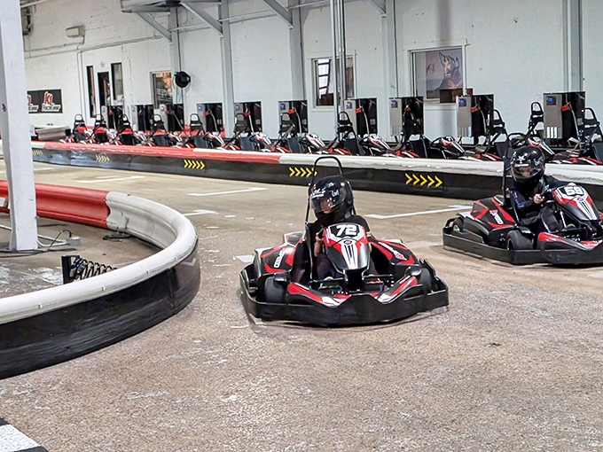 The checkered flag awaits as electric karts zoom around K1 Speed's professionally designed indoor track. Racing dreams come true regardless of weather outside.