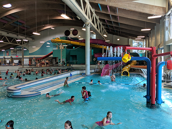The aquatic playground of your dreams! Colorful slides twist and turn above the wave pool, promising adventures that'll make you forget you're indoors in Oregon.