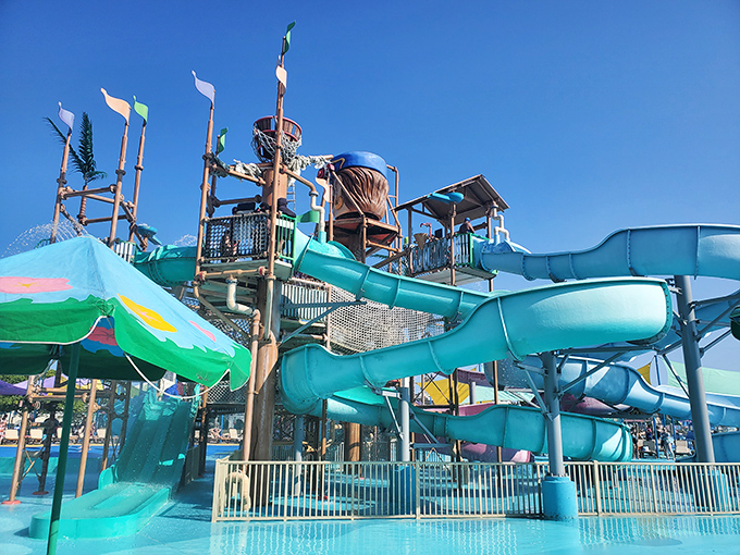 A rainbow of water slides cascades into crystal blue pools, promising the kind of summer day that makes winter worth enduring.