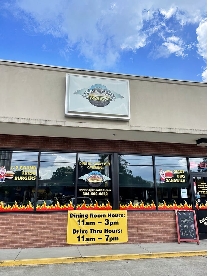 The flames painted along the storefront aren't just decoration&mdash;they're a warning to your diet plans. Ridge View BBQ's exterior promises smoky delights within.