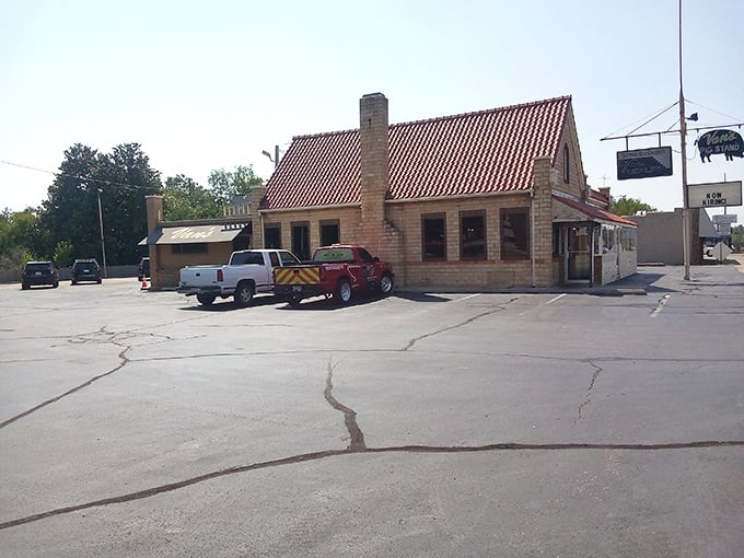 The iconic orange roof and stone exterior of Van's Pig Stand stands as a beacon of barbecue hope on Shawnee's horizon, promising smoky delights within.