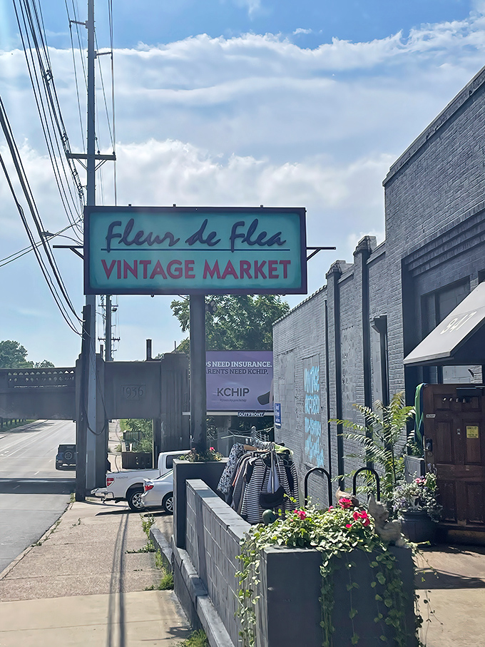 The turquoise sign beckons like a vintage siren song, promising treasures behind those brick walls that your modern big-box stores couldn't dream of housing.
