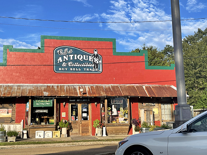 The vibrant red facade of C.J.'s Antiques & Collectibles stands out like a beacon for treasure hunters, promising adventures in nostalgia beneath that rustic metal roof.