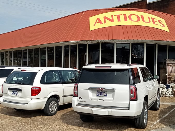 Peek down a corridor of curiosities where treasure hunters navigate a sea of vintage wonders under the watchful eye of a blue bicycle suspended in mid-flight. 