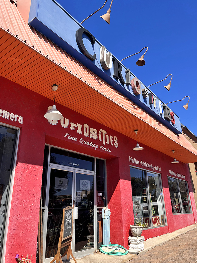 The vibrant red exterior of Curiosities stands out like a beacon of eccentricity, promising treasures that would make any collector's heart skip a beat.