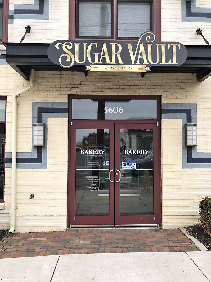 The unassuming storefront of Sugar Vault beckons like a secret treasure map to dessert paradise. Yellow brick, red doors, and sweet promises await.