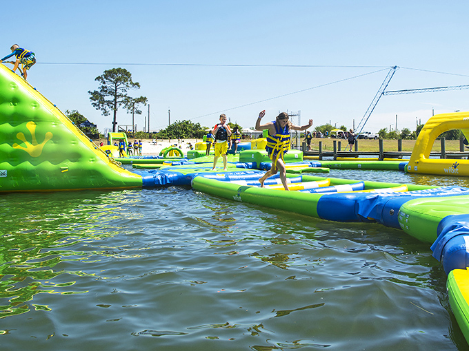 The neon green floating playground beckons like an aquatic Wonderland. Who needs expensive theme parks when paradise is floating right here?