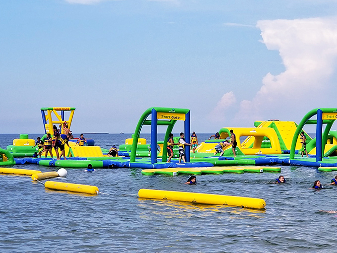 The ultimate adult recess has arrived! Vibrant yellow and green inflatables bob on Lake Michigan's blue waters, promising aquatic adventures that'll make your inner child squeal with delight.