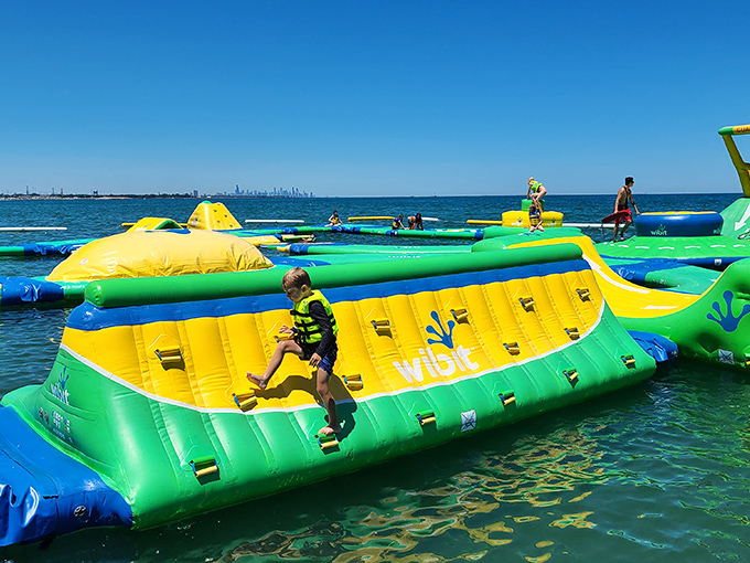 The ultimate adult recess has arrived! Vibrant yellow and green inflatables bob on Lake Michigan's blue waters, promising aquatic adventures that'll make your inner child squeal with delight.