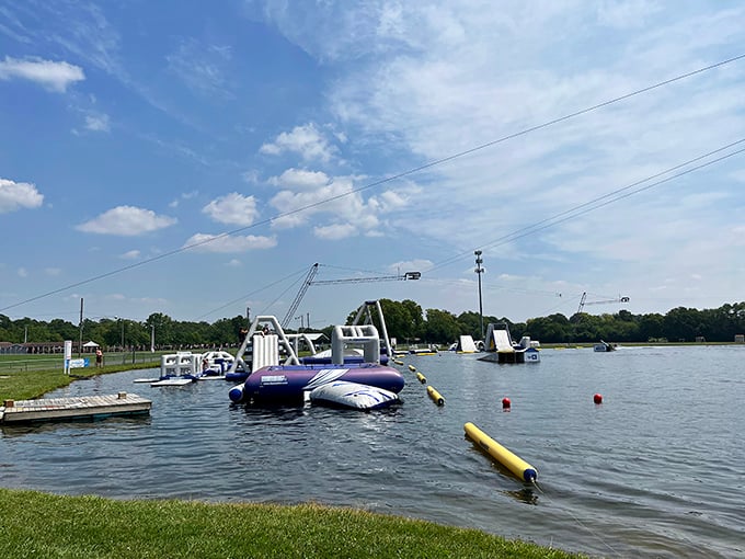 Blue and white inflatable obstacles dot the lake like a playground designed by someone who really understands the joy of controlled chaos.