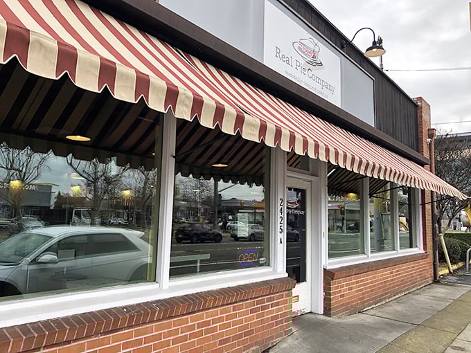The red-and-white striped awning isn't just charming - it's nature's way of signaling "life-changing pie ahead," like a delicious warning system for your taste buds.