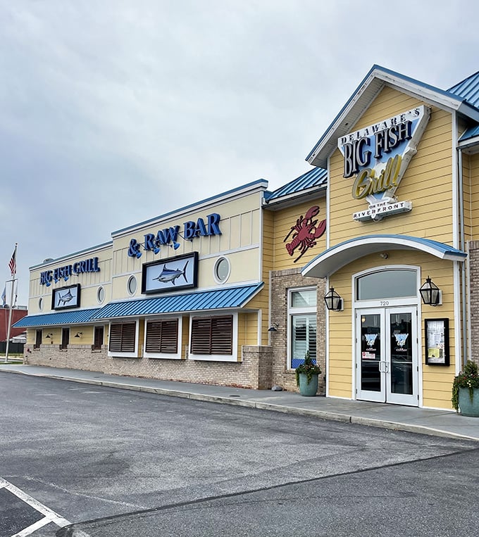 The cheerful yellow exterior of Big Fish Grill beckons like a maritime lighthouse for hungry souls. Blue accents and nautical touches promise seafood salvation ahead.