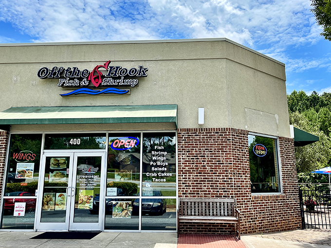 The neon glow of Off The Hook beckons like a lighthouse for the seafood-starved, promising fried treasures within its unassuming brick walls.