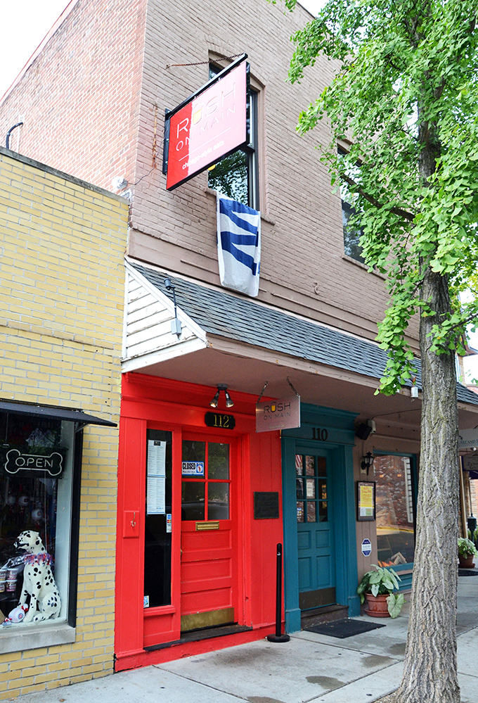 The bright red door at Rush on Main stands out like a beacon on Zionsville's Main Street, promising Chicago-style delights within these historic walls.