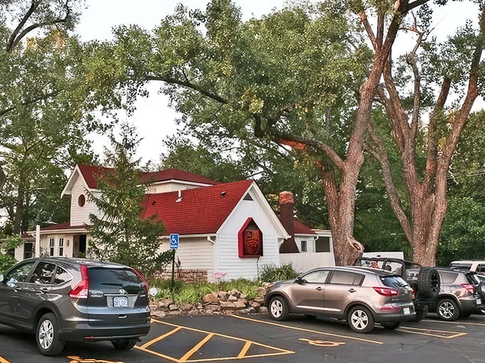 The charming cottage-like exterior of Grinders Stonewall beckons with its red-trimmed sign and helpful "ENTER OVER HERE" arrow&mdash;like your coolest friend's secret hideaway.