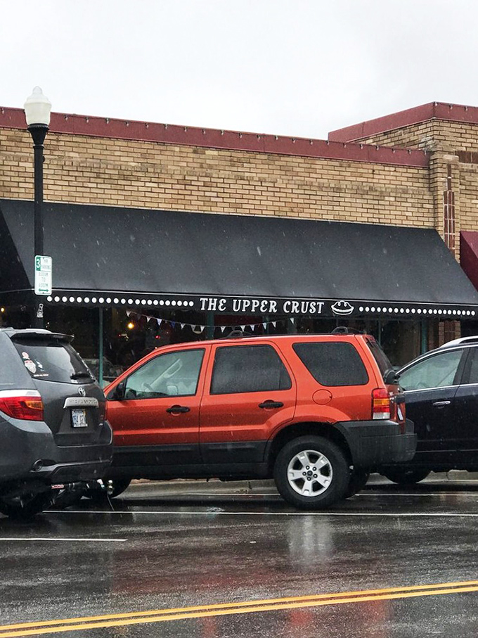 The unassuming storefront of The Upper Crust beckons like a siren song to pie lovers. That navy awning and bright red door are basically saying, "Get in here, hungry person!"