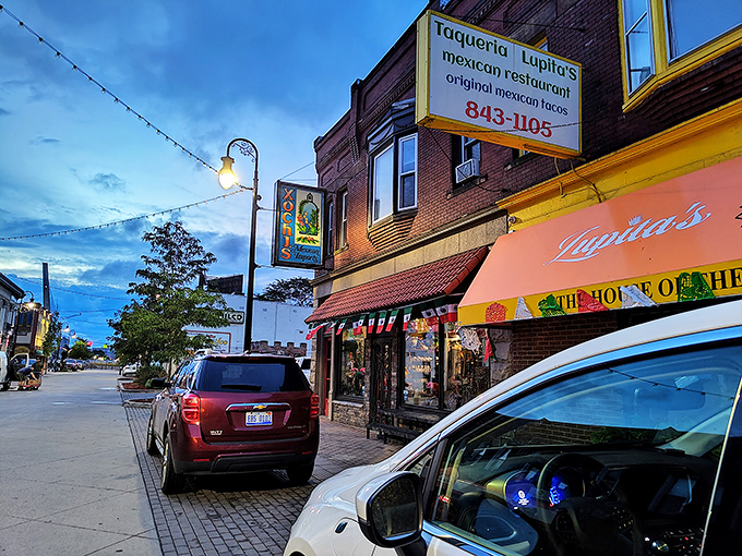 The bright orange awning of Taqueria Lupitas stands out like a beacon of culinary hope on this Detroit street corner, promising authentic Mexican flavors within.