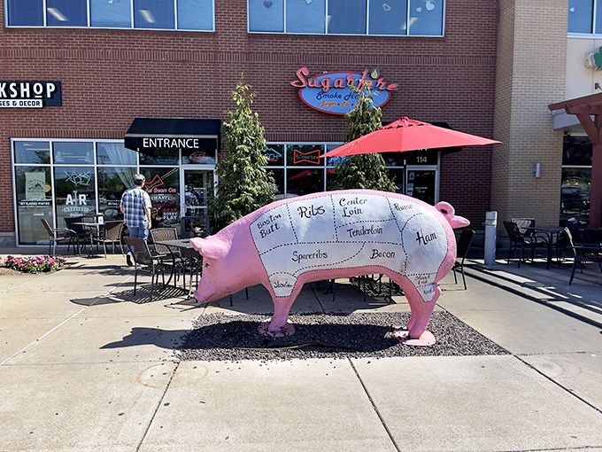 The brick-and-mortar temple of smoke beckons with its cheerful blue sign and red neon "BARBECUE" promise&mdash;a siren call to hungry travelers.
