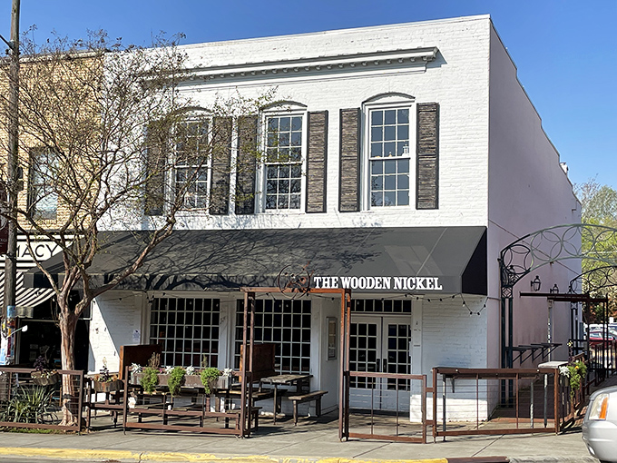 The Wooden Nickel's classic white facade stands proudly on Hillsborough's King Street, beckoning hungry travelers with the promise of comfort and conversation.