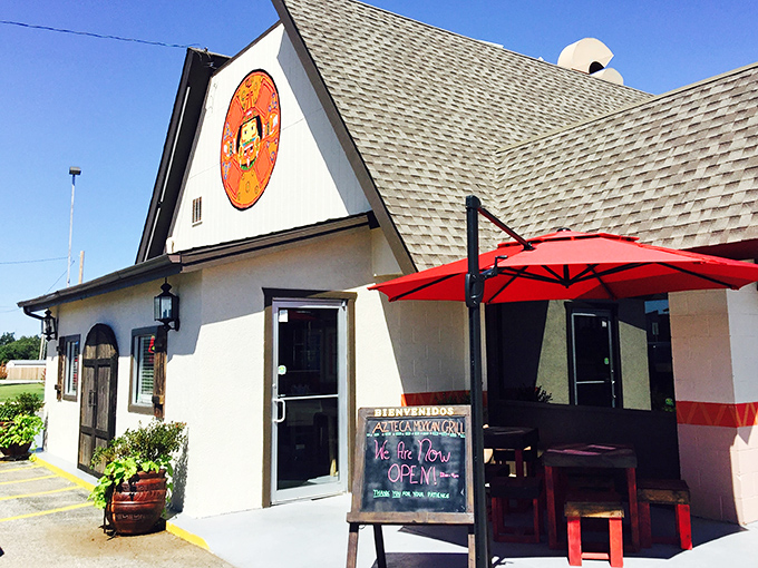 The charming A-frame exterior with its welcoming red umbrellas feels like discovering a secret portal to Mexico right in Oklahoma City.