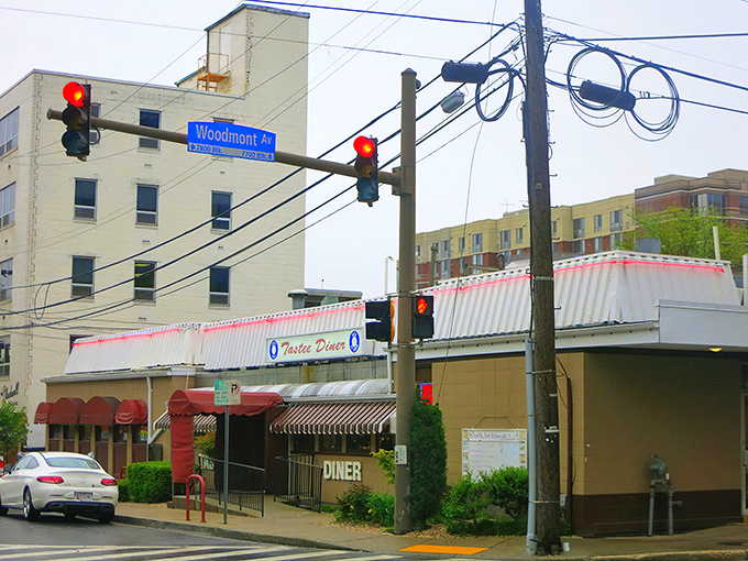 The stainless steel exterior of Tastee Diner stands defiant against time, its red and white awning a beacon for breakfast pilgrims seeking authenticity in Bethesda.