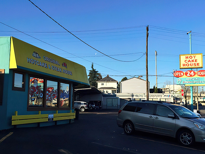 The turquoise and yellow exterior stands like a beacon of breakfast hope on Powell Boulevard, promising 24-hour satisfaction for hungry Portlanders.