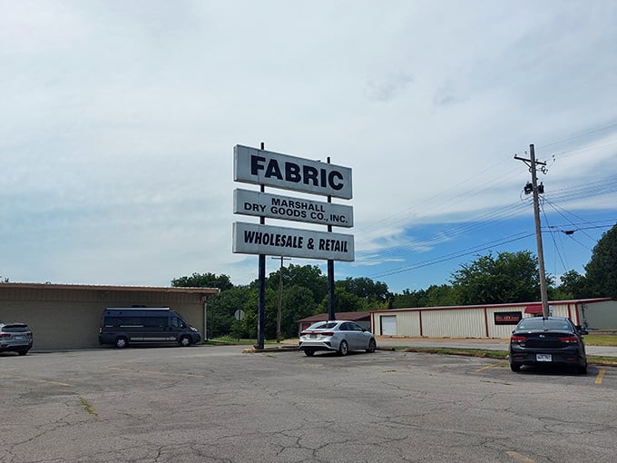 The sign says "FABRIC" with the subtlety of a Broadway marquee. No false advertising here&mdash;just a promise of textile treasures awaiting inside.